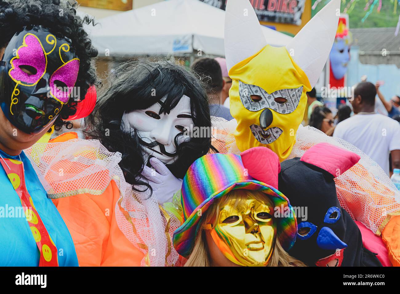 Five masked people with colorful costumes during a carnival in Salvador ...