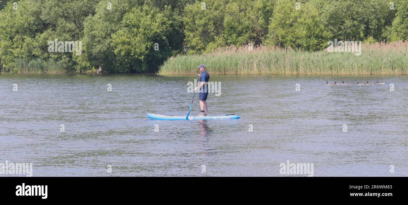 Sale Water Park, Trafford, Greater Manchester, man paddle boarding on ...
