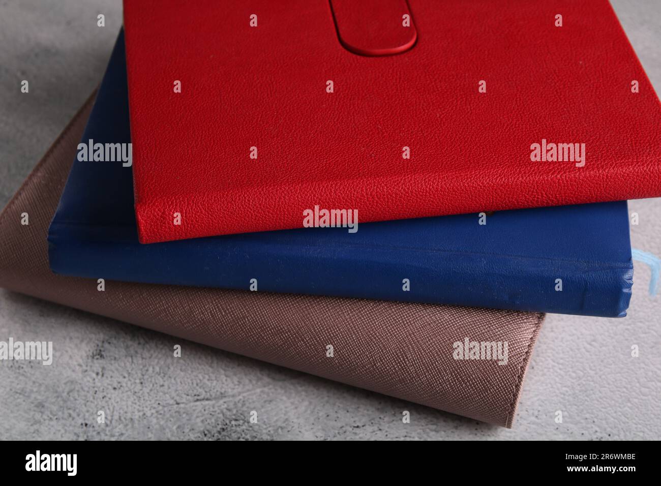 photo notebooks of different colors lying on the table on top of each ...