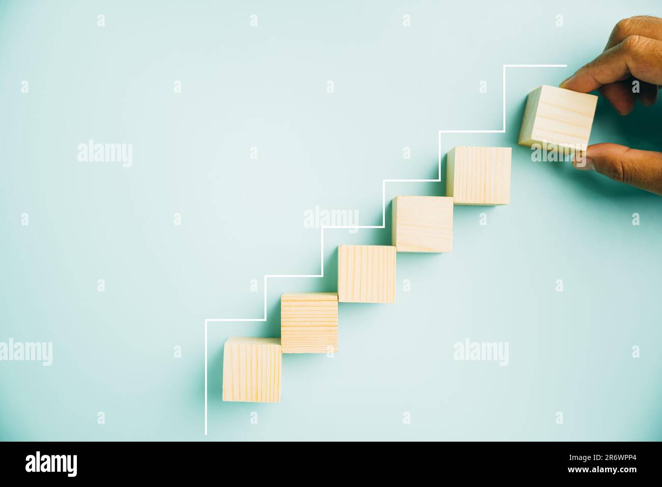 Wooden block stacking represents the ladder of success in business ...