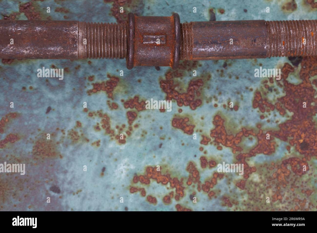 Rusty valve pipes on rusty metal wall background Stock Photo - Alamy