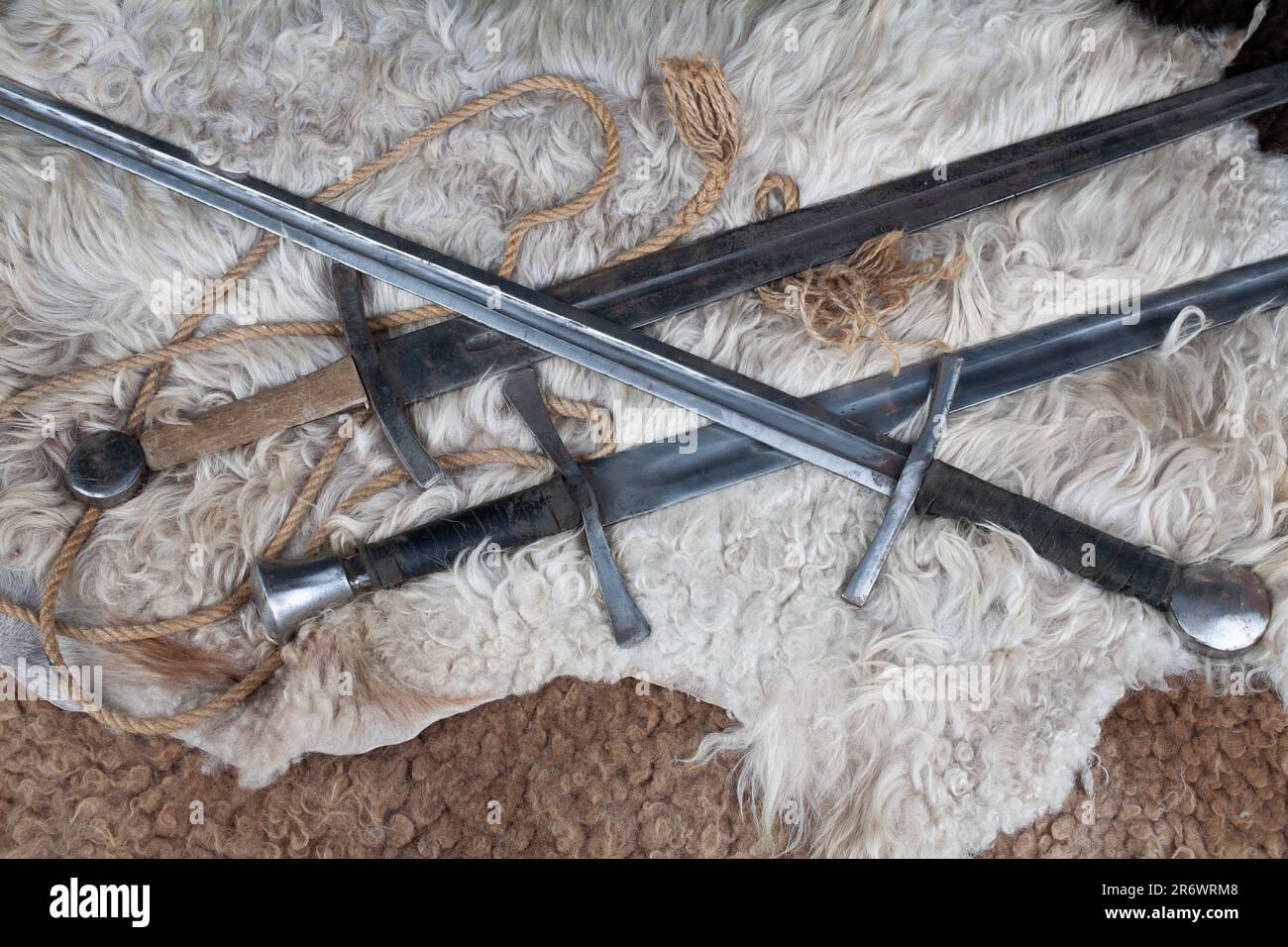 Medieval swords on sheep fur background Stock Photo - Alamy