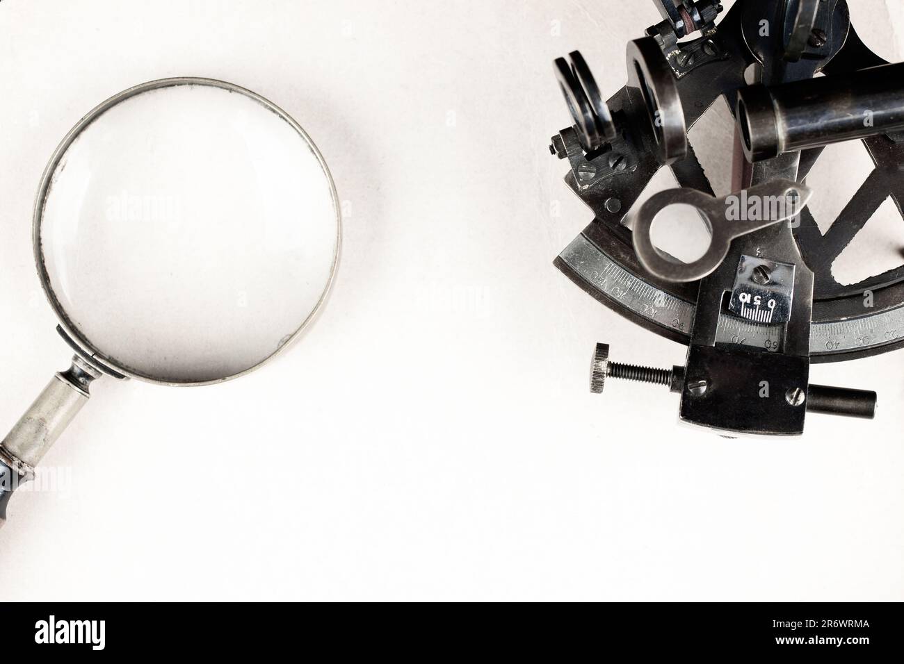 Antique bronze sextant on old paper background Stock Photo - Alamy