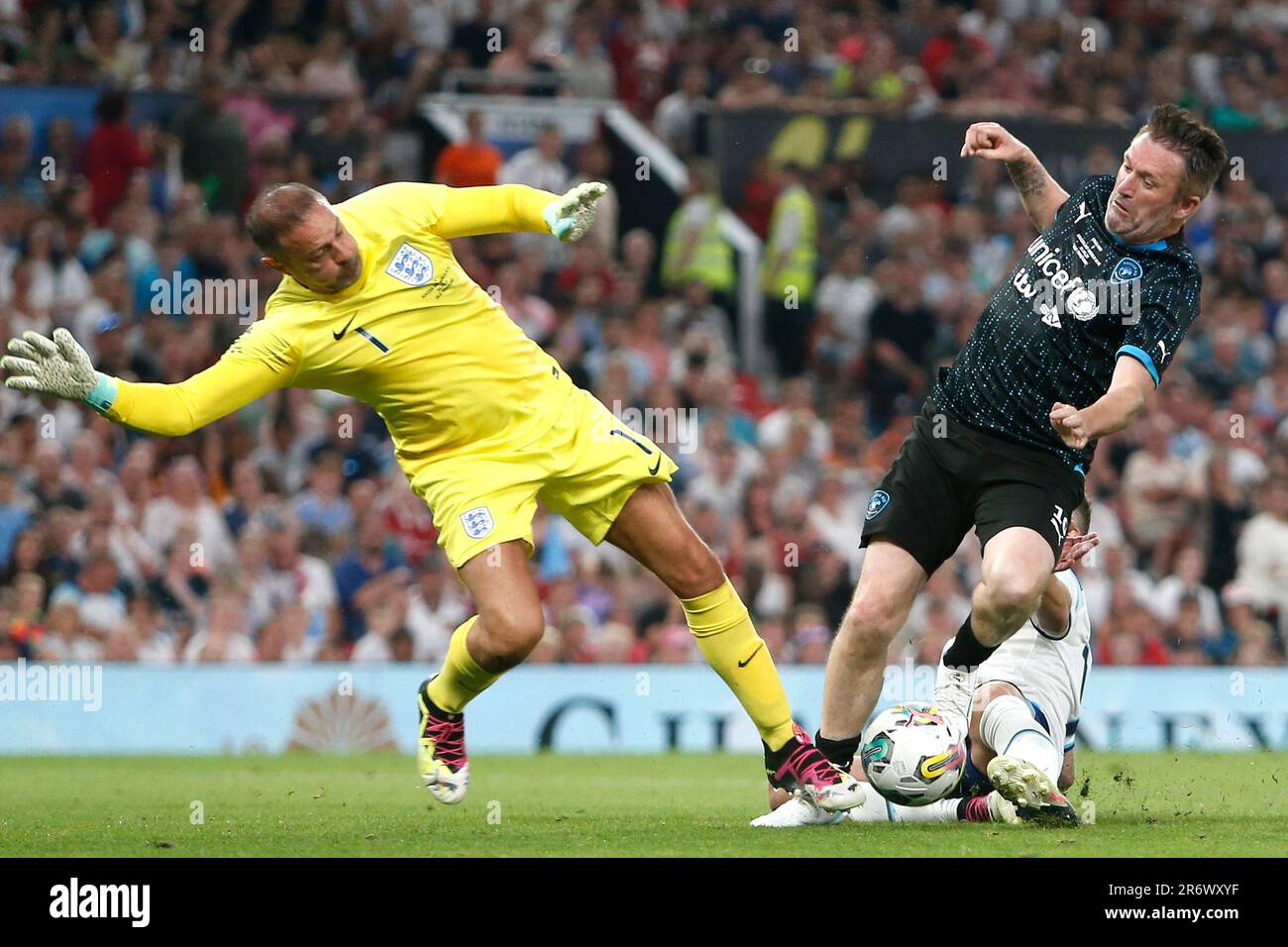 England goalkeeper Paddy McGuinness (left) tackles Soccer Aid World XI ...