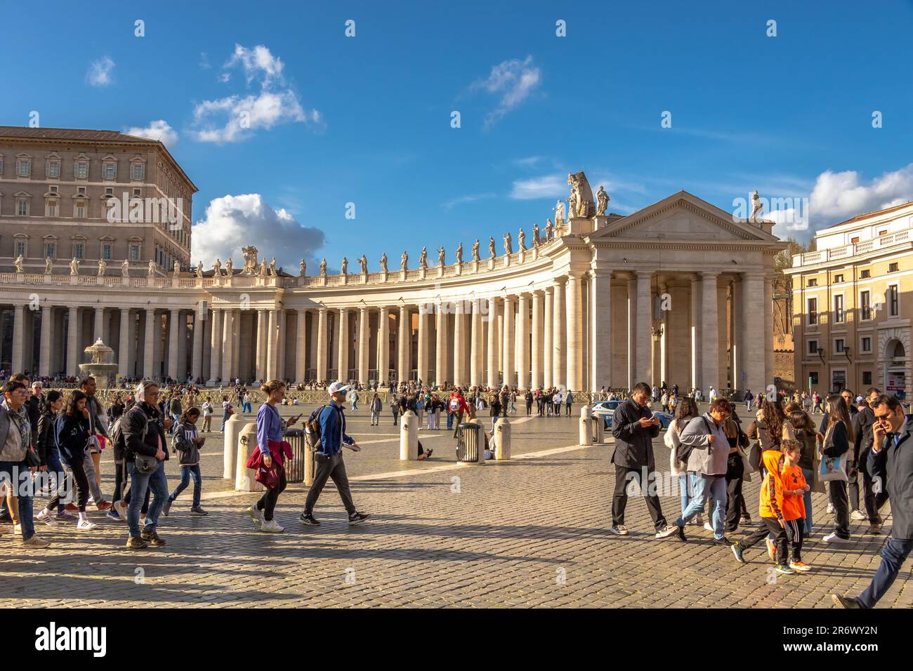 People at St Peter's Square, a large plaza located directly in front of ...