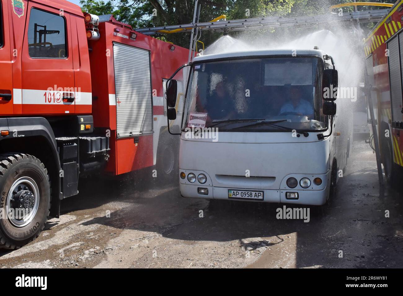 A passenger bus seen under a cleaning shower with a decontamination ...