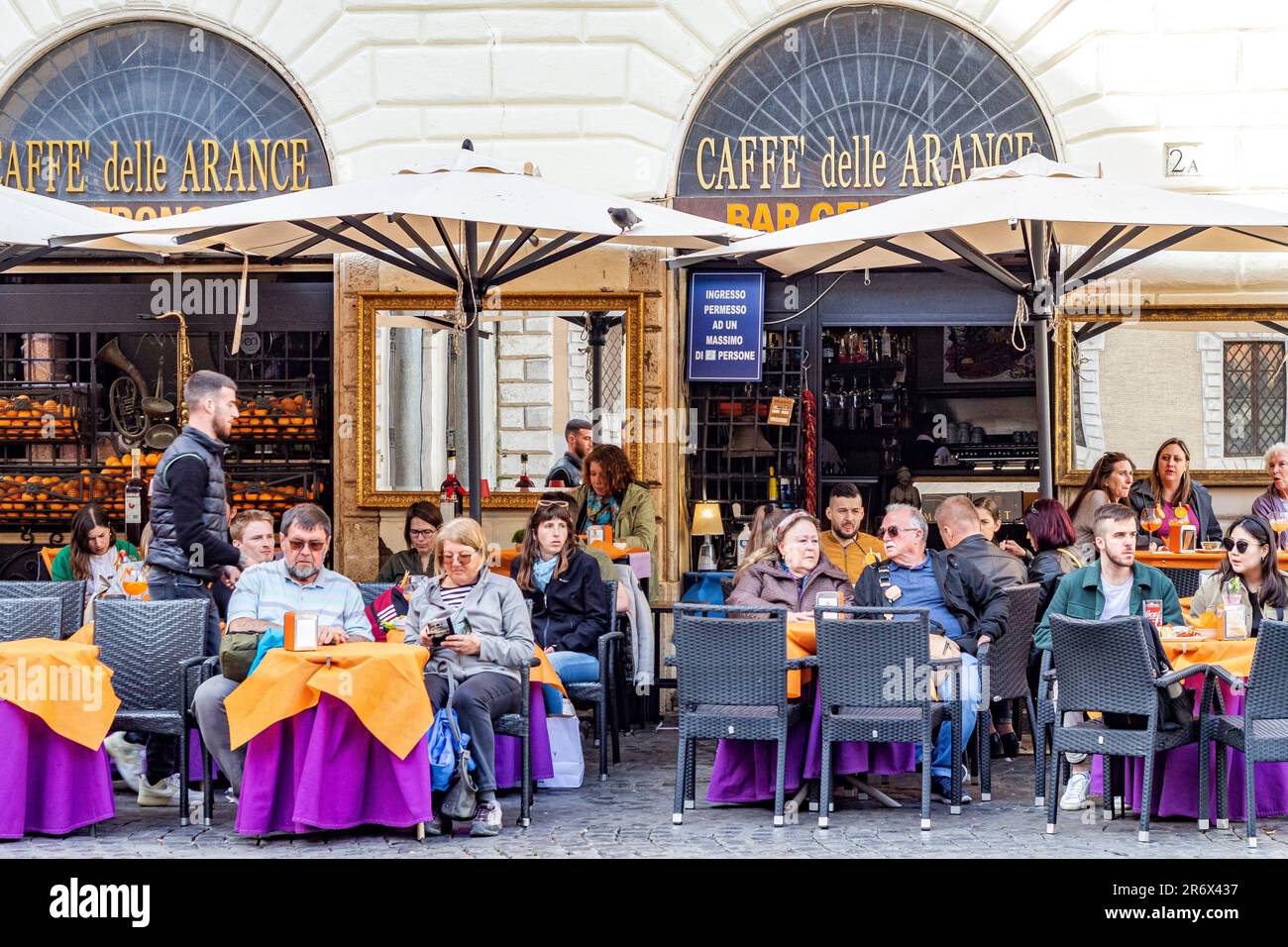 People enjoying drinks outside at Caffè delle Arance in Trastevere ...