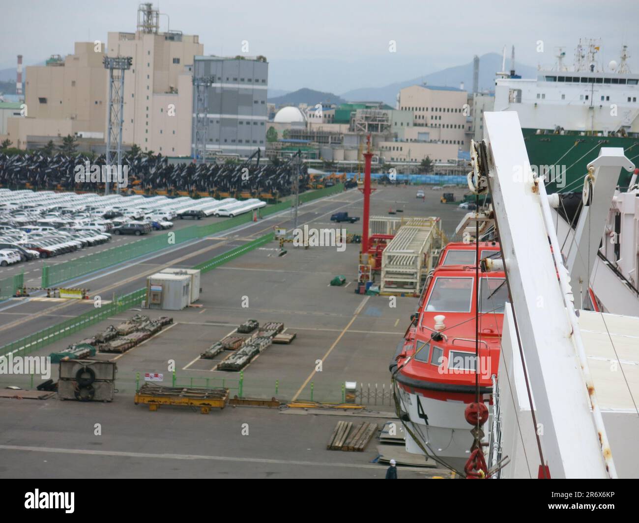 A cruise ship moored at the Port of Ulsan in South Korea has a view of ...