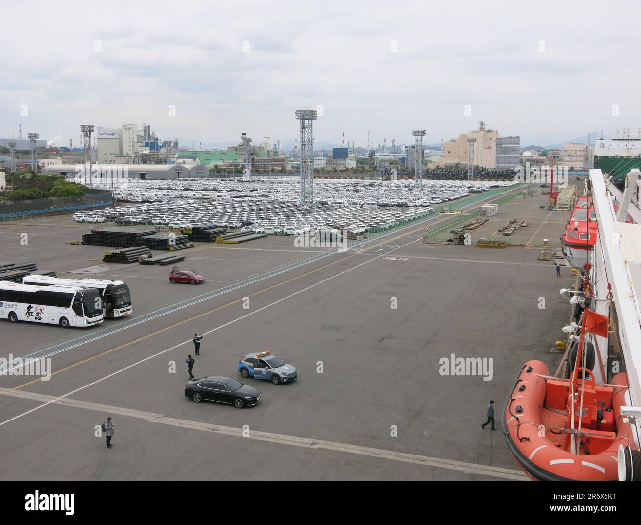 A cruise ship moored at the Port of Ulsan in South Korea has a view of ...