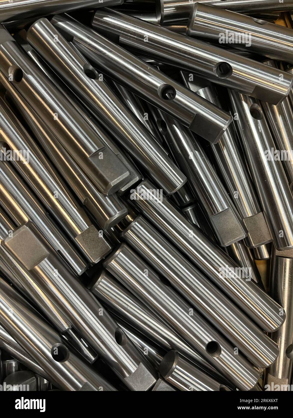 A close-up shot of a collection of machined steel shaft spread ...