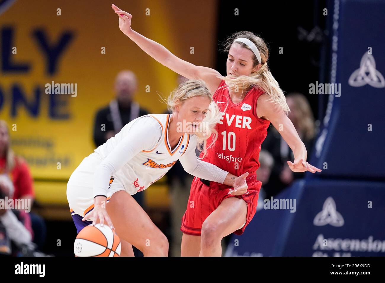 Phoenix Mercury's Sophie Cunningham, left, is defended by Indiana Fever's Lexie Hull (10) during ...