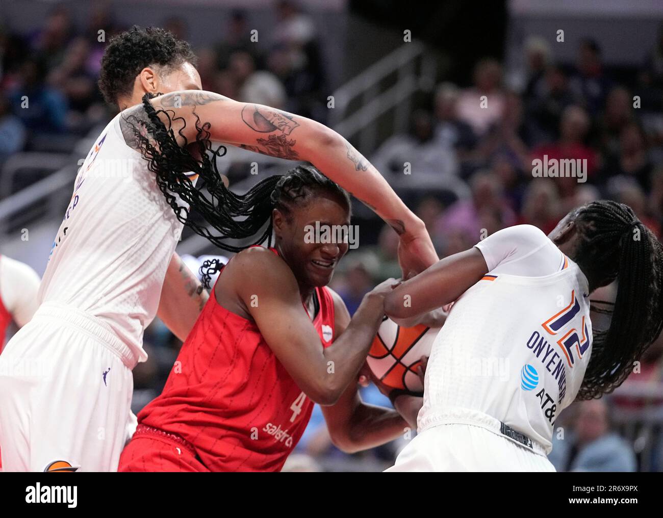Indiana Fever's Queen Egbo (4) is tied up by Phoenix Mercury's Michaela ...