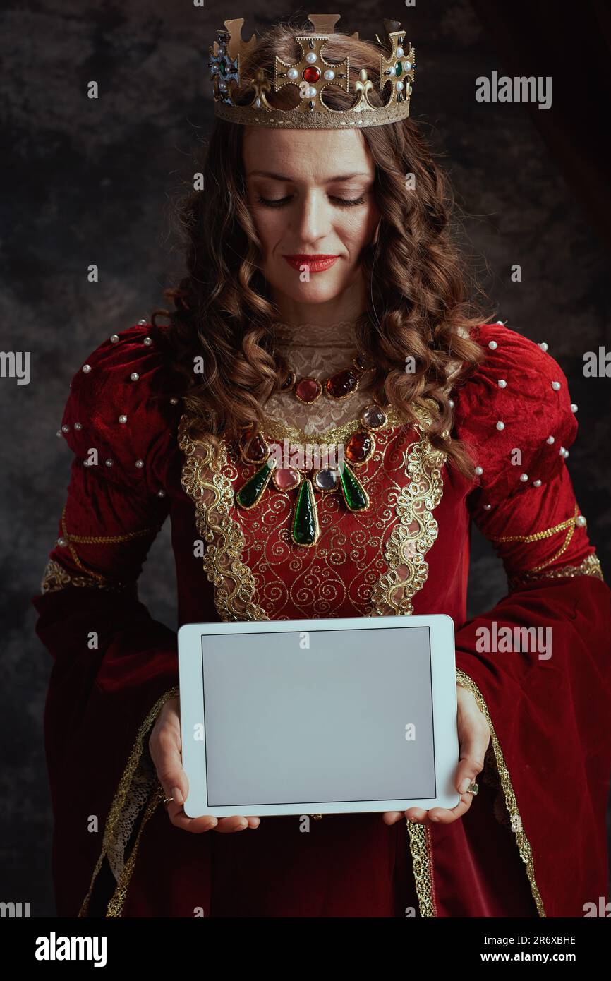 medieval queen in red dress with crown digital tablet blank screen on ...