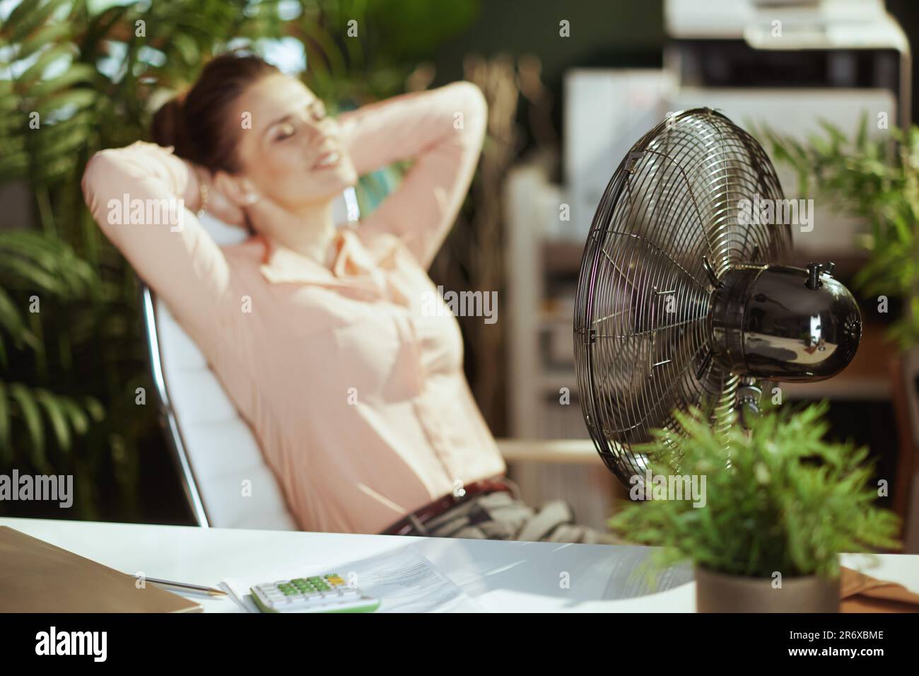 Sustainable workplace. Closeup on relaxed modern woman worker at work ...