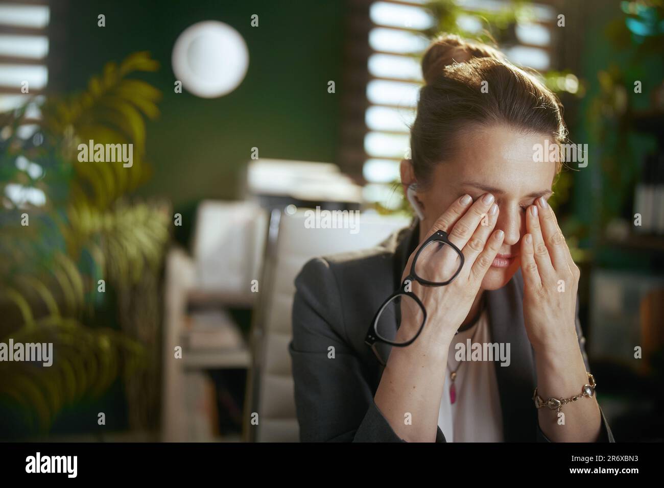 Sustainable workplace. tired modern small business owner woman at work ...