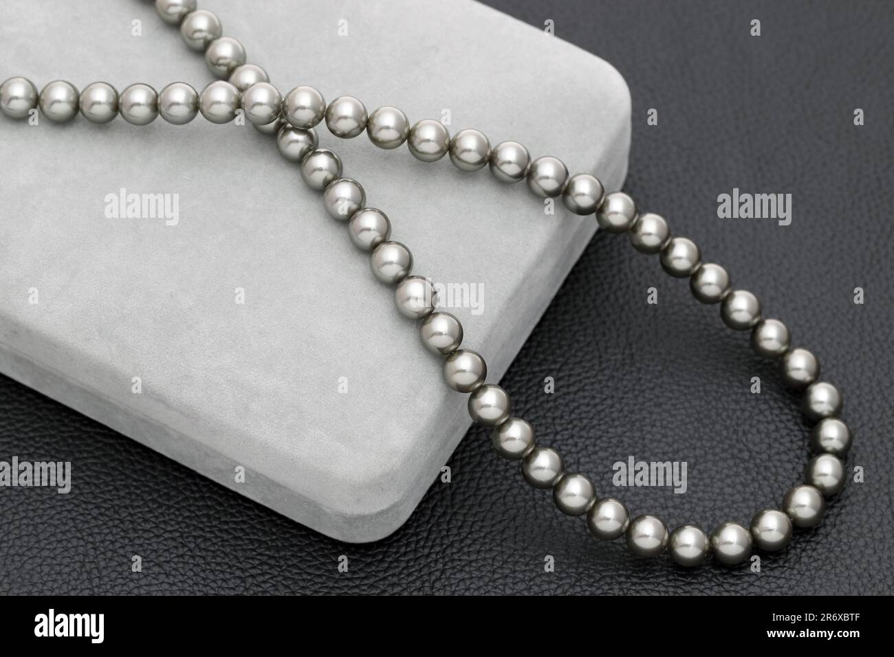 Elegant black pearl necklace on black background Stock Photo - Alamy