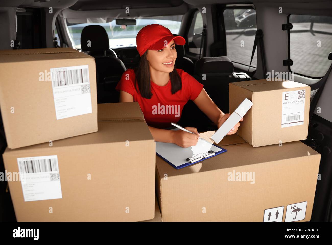 Female courier checking packages hi-res stock photography and images ...