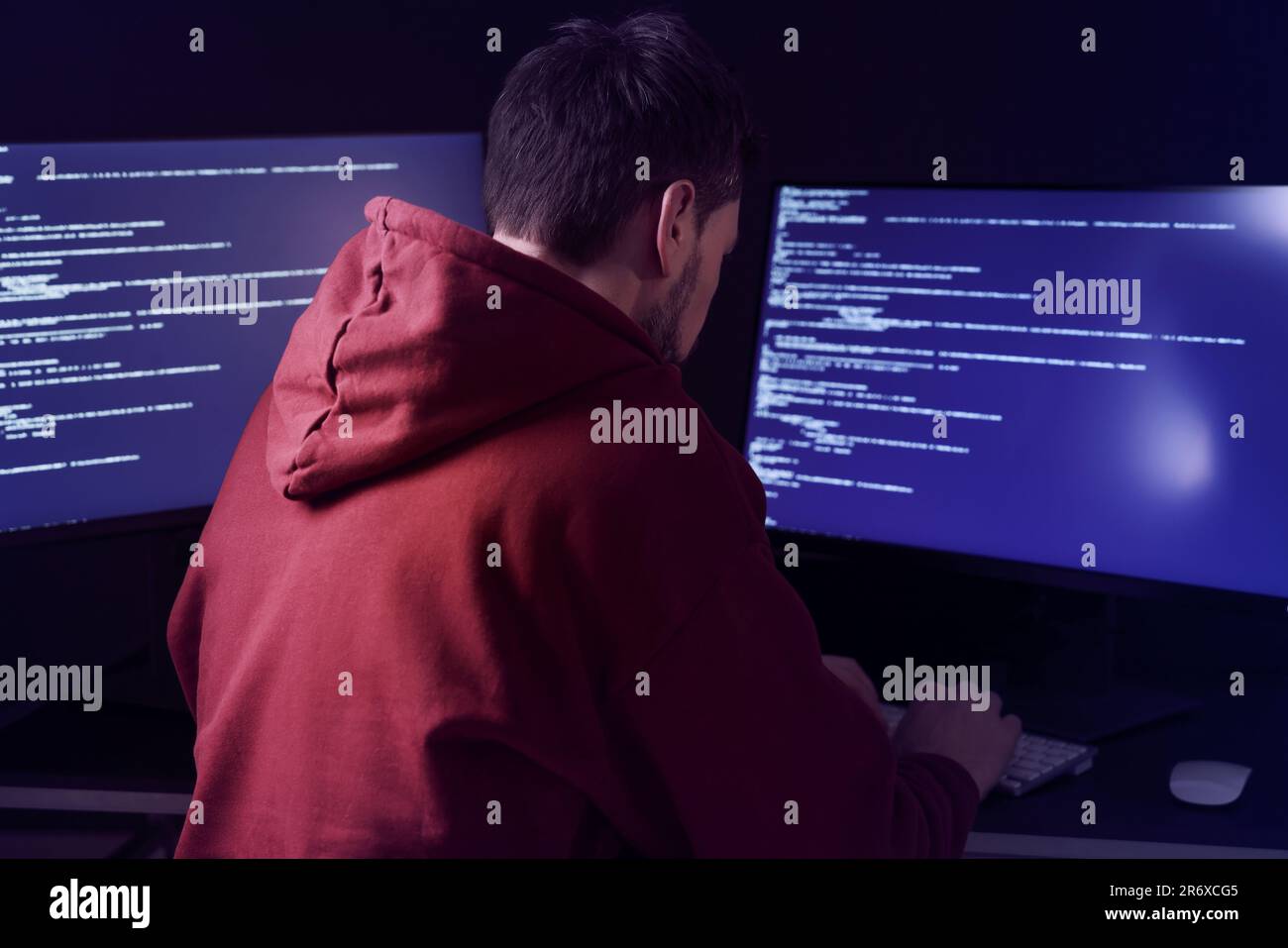 Hacker working with computers in dark room. Cyber attack Stock Photo - Alamy