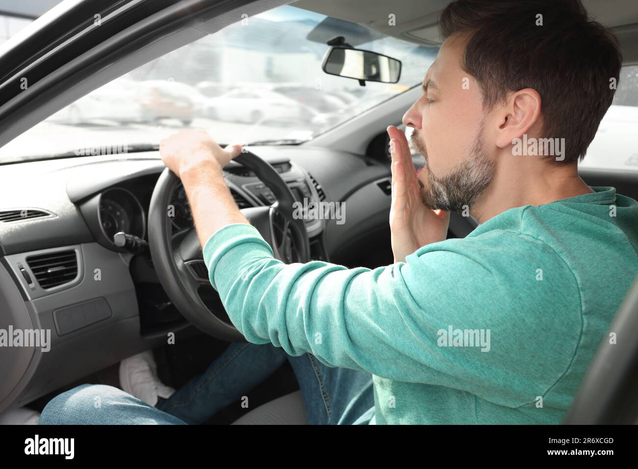 Sleepy tired man yawning in his modern car Stock Photo - Alamy