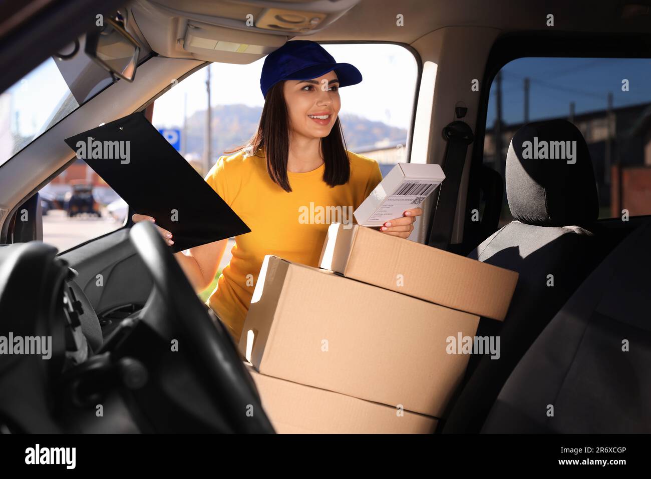 Female courier checking packages hi-res stock photography and images ...