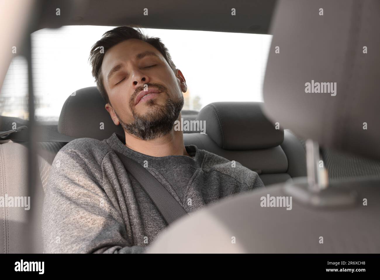 Tired handsome man sleeping in his car Stock Photo - Alamy