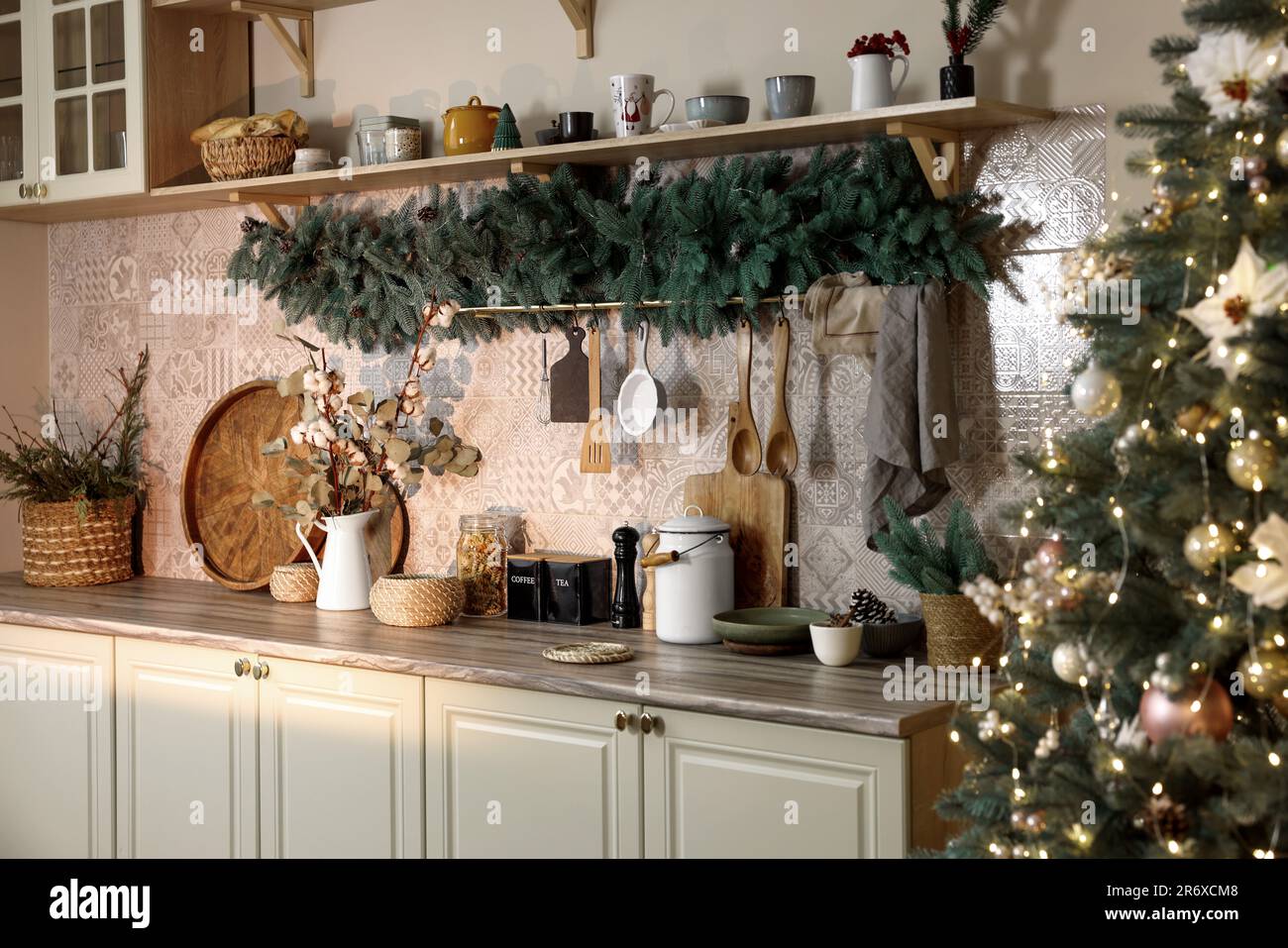 Stylish kitchen with festive decor and Christmas tree. Interior design ...