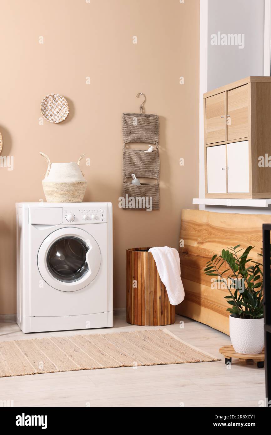 Stylish laundry room with modern washing machine. Interior design Stock ...