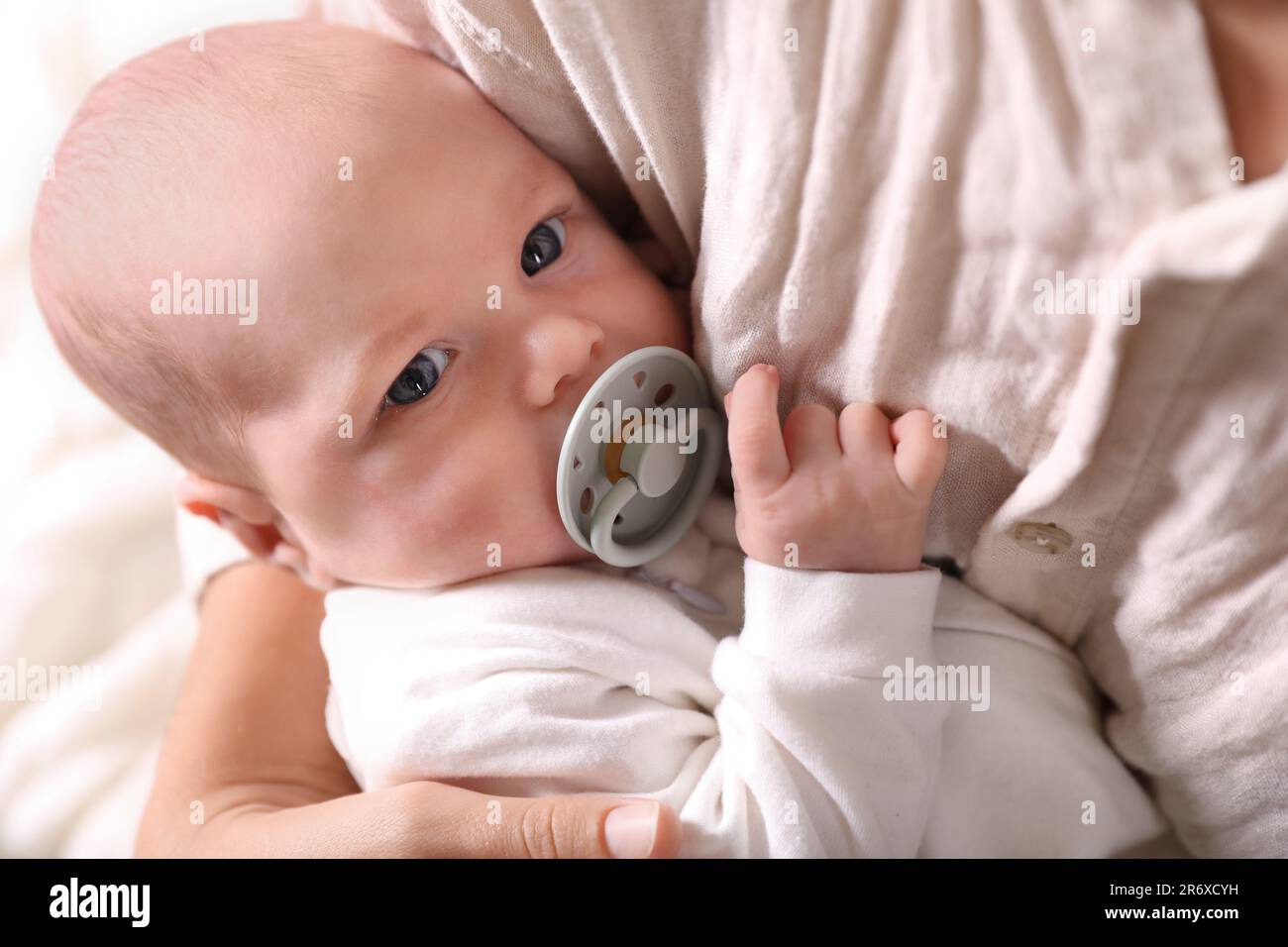 Mother hugging cute newborn baby on bed, closeup Stock Photo - Alamy
