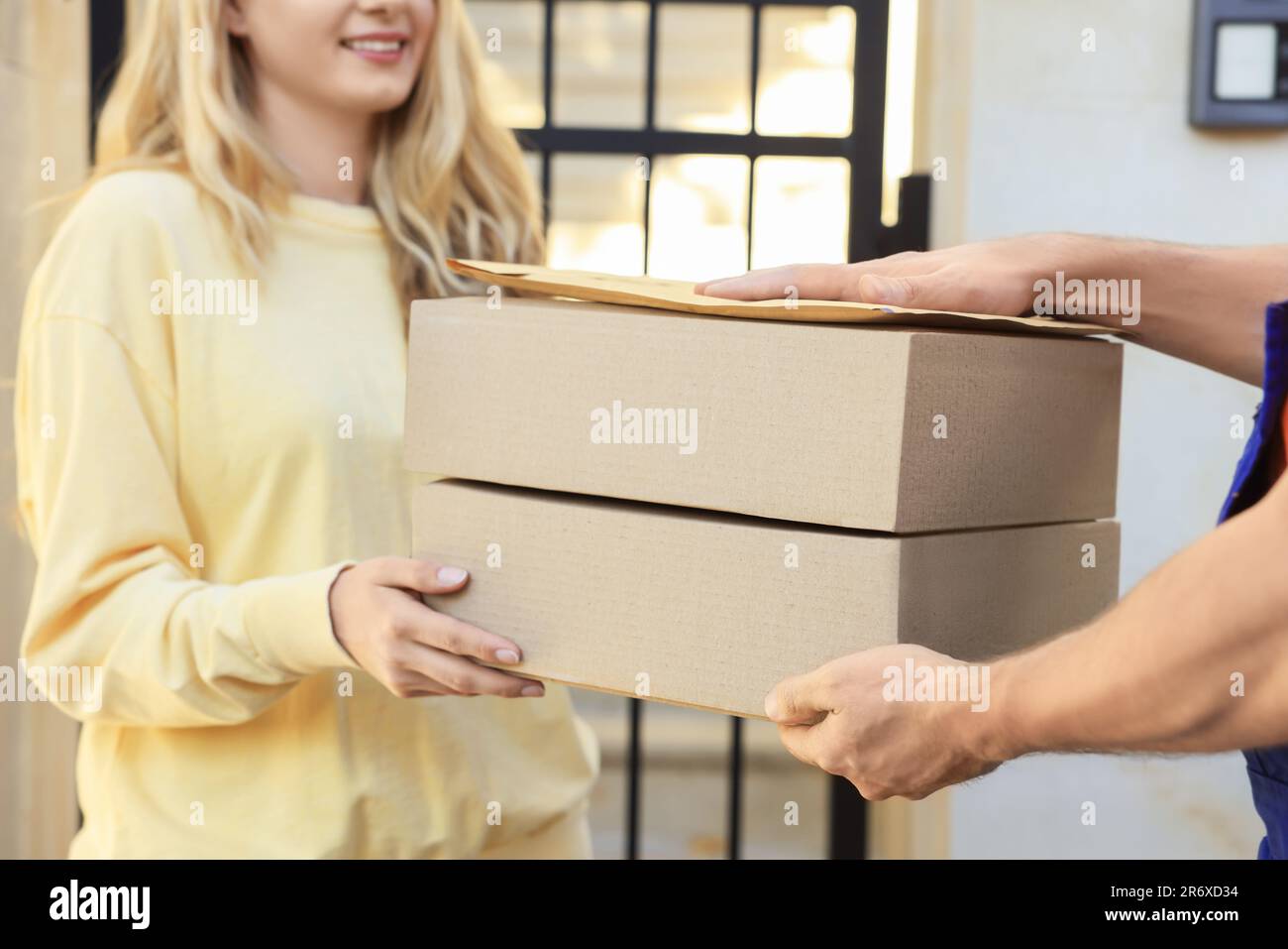 Woman receiving parcels from hi-res stock photography and images - Alamy
