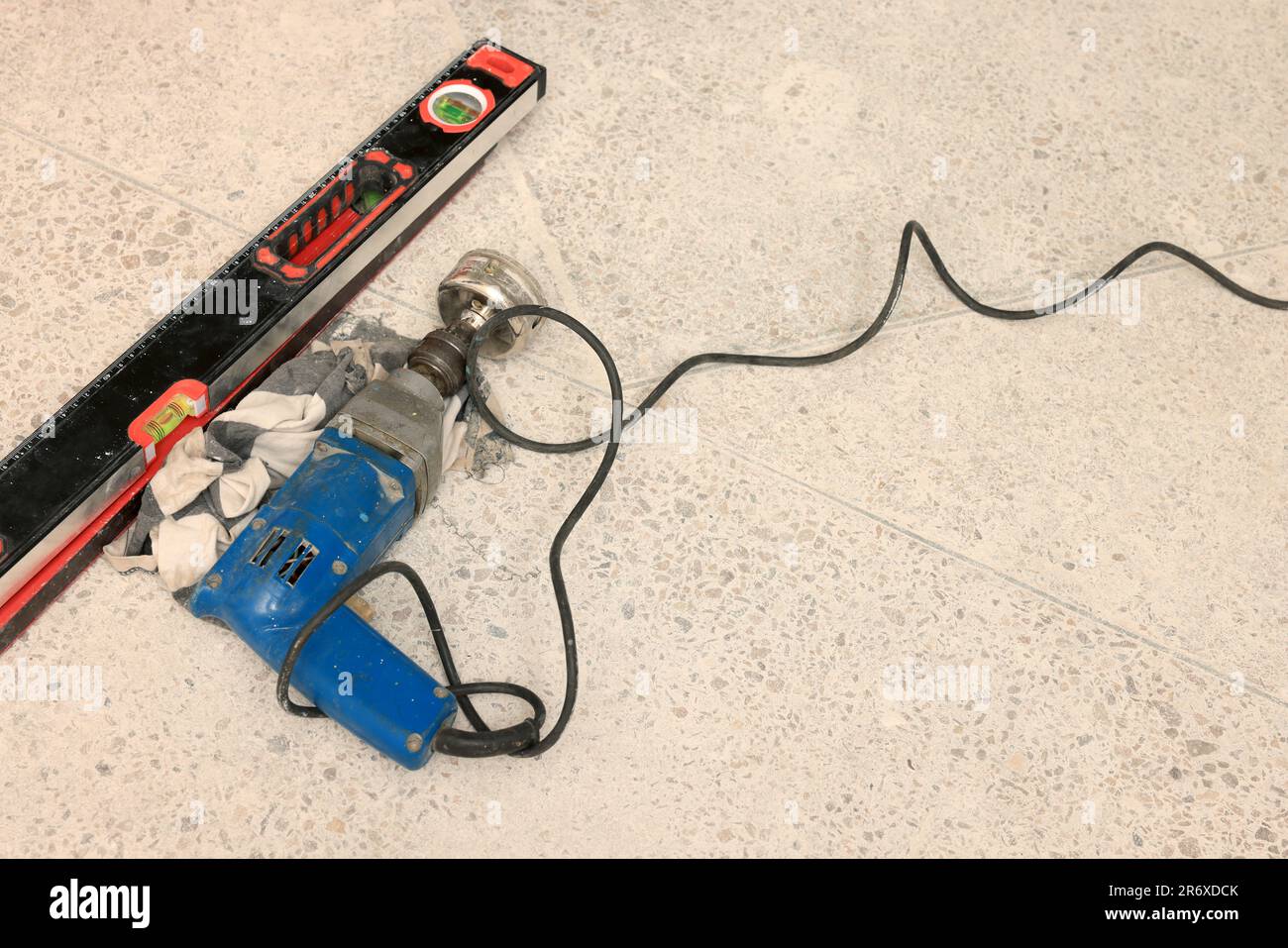 Buffing attachment drill and building level on floor. Tiles ...