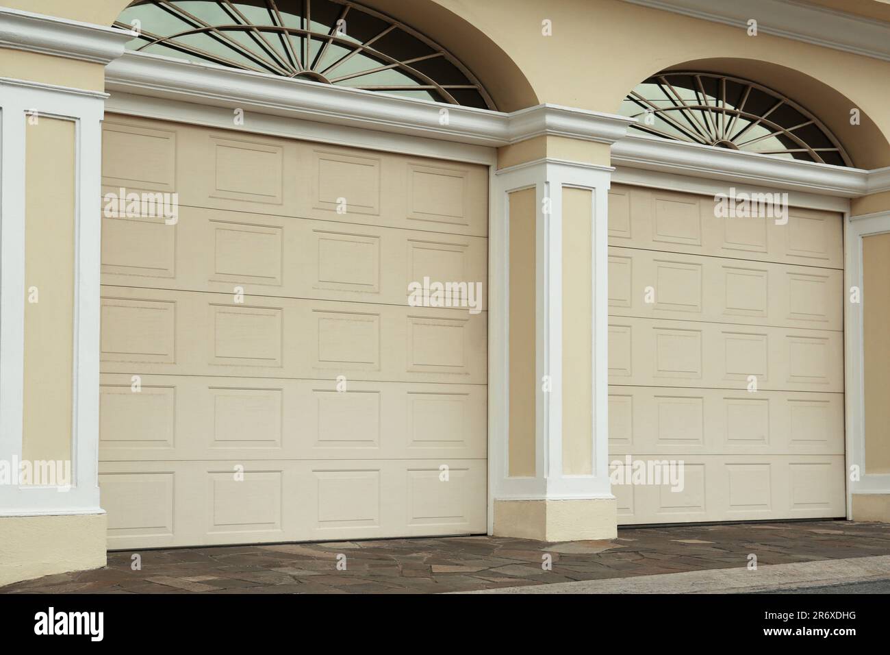 Building with beige sectional garage doors outdoors Stock Photo - Alamy