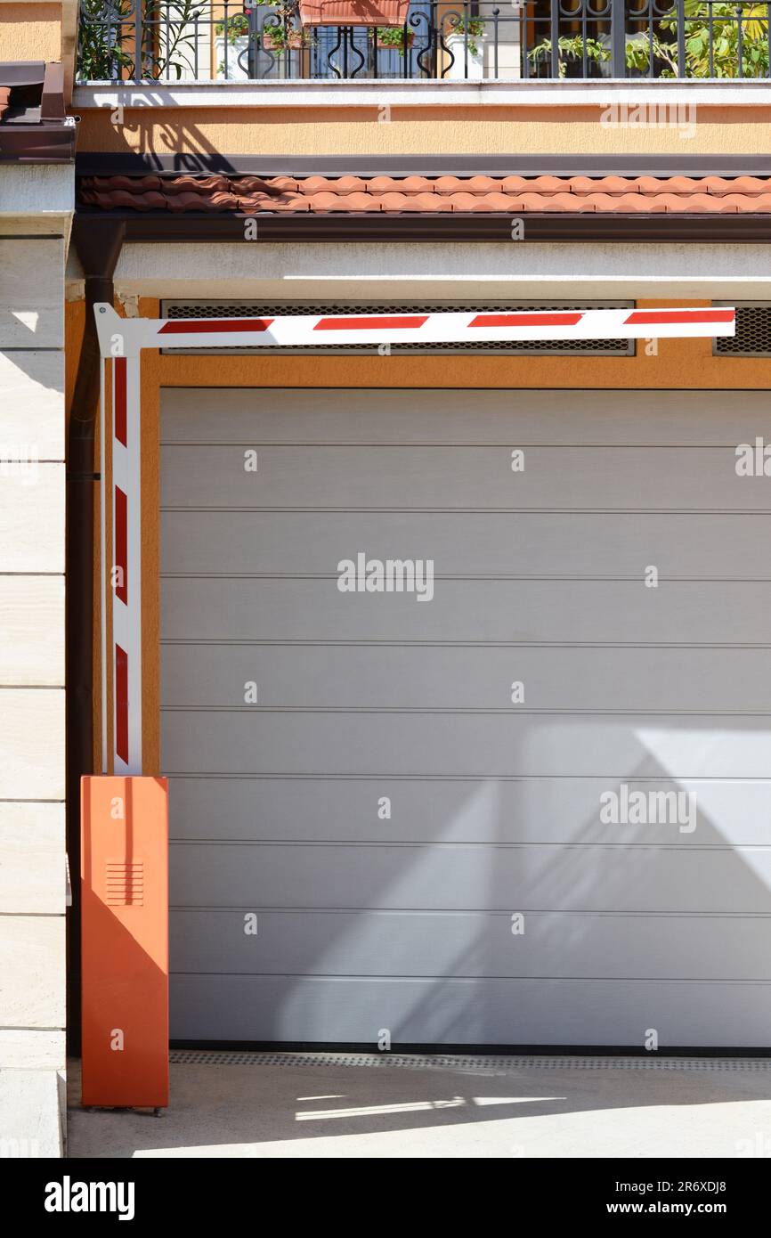 Modern automatic striped barrier near garage outdoors Stock Photo - Alamy