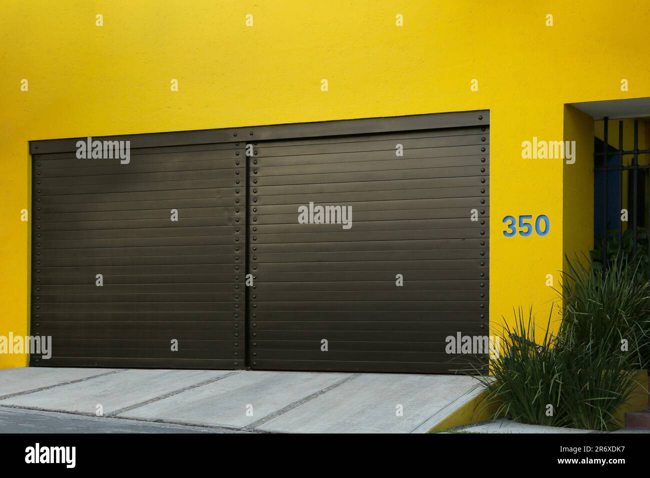 Closed gates of modern garage. Exterior design Stock Photo - Alamy