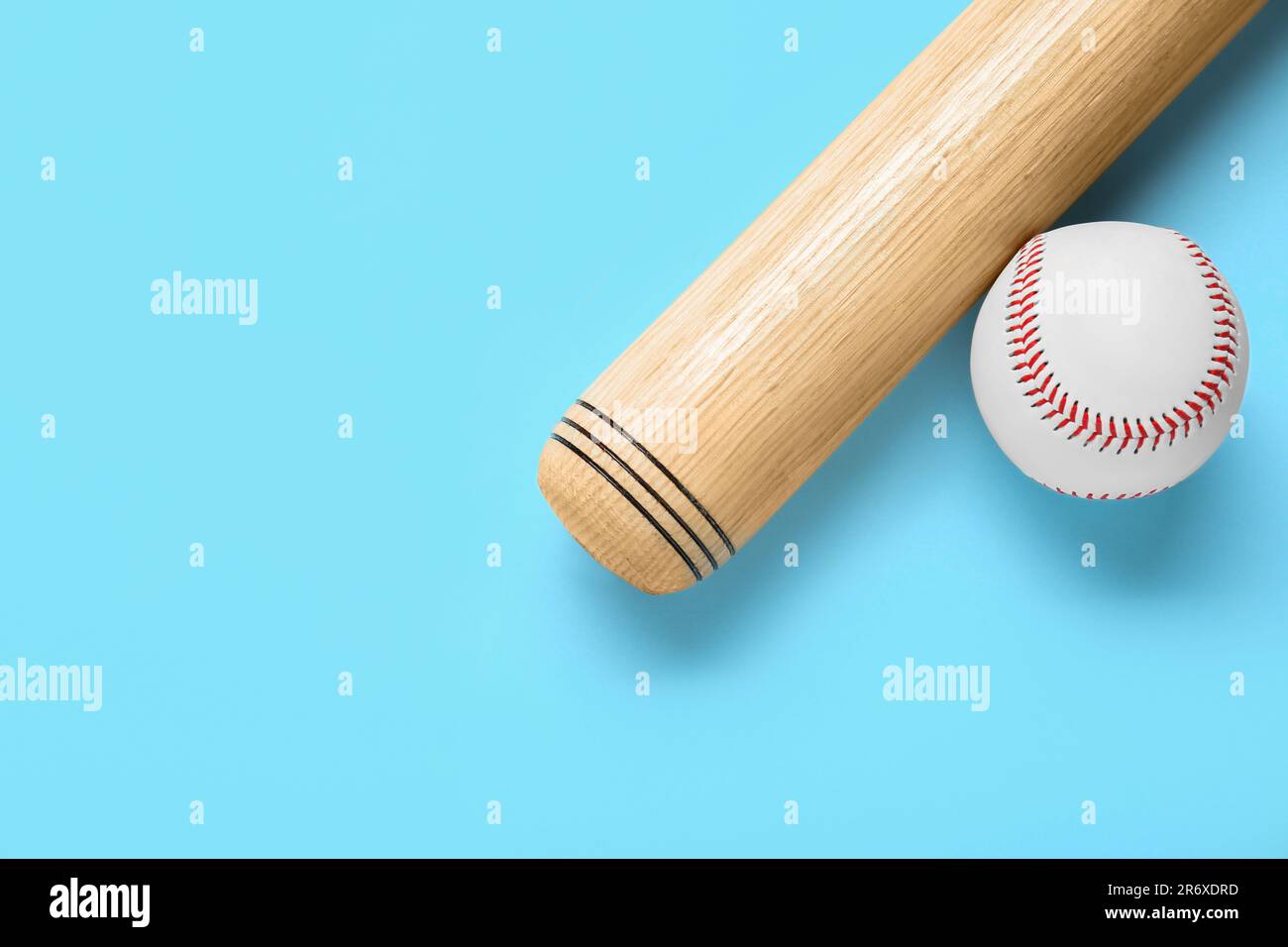 Wooden baseball bat and ball on light blue background, flat lay. Space ...