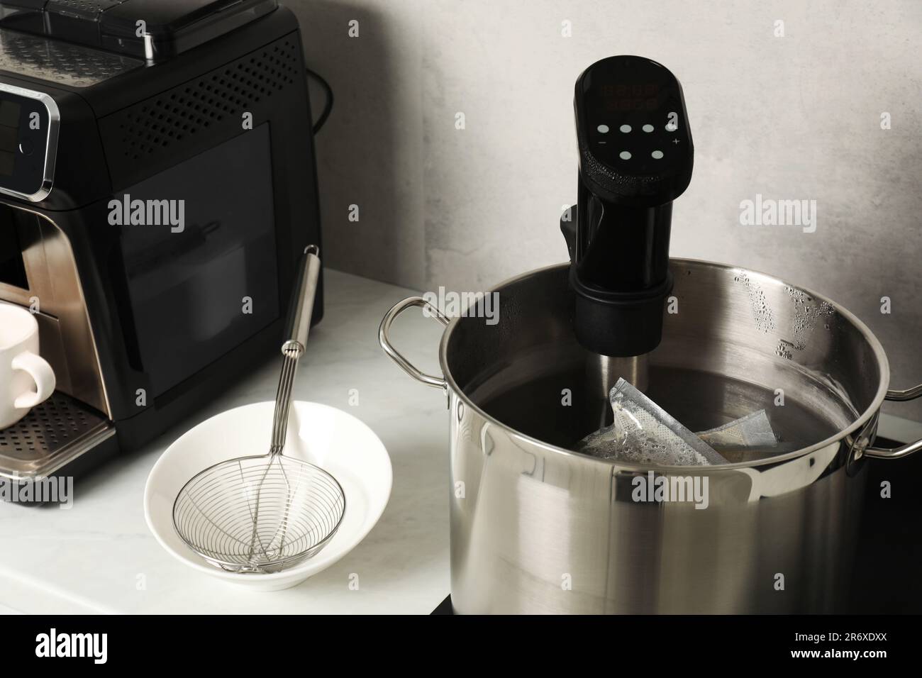 Sous vide cooker and vacuum packing in pot. Thermal immersion ...