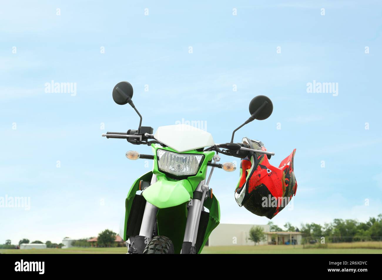 Stylish green cross motorcycle with helmet outdoors Stock Photo - Alamy