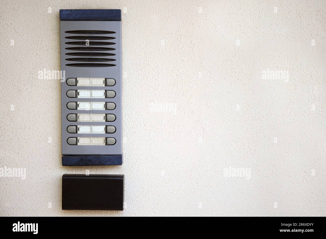 Modern intercom on beige wall, space for text Stock Photo - Alamy