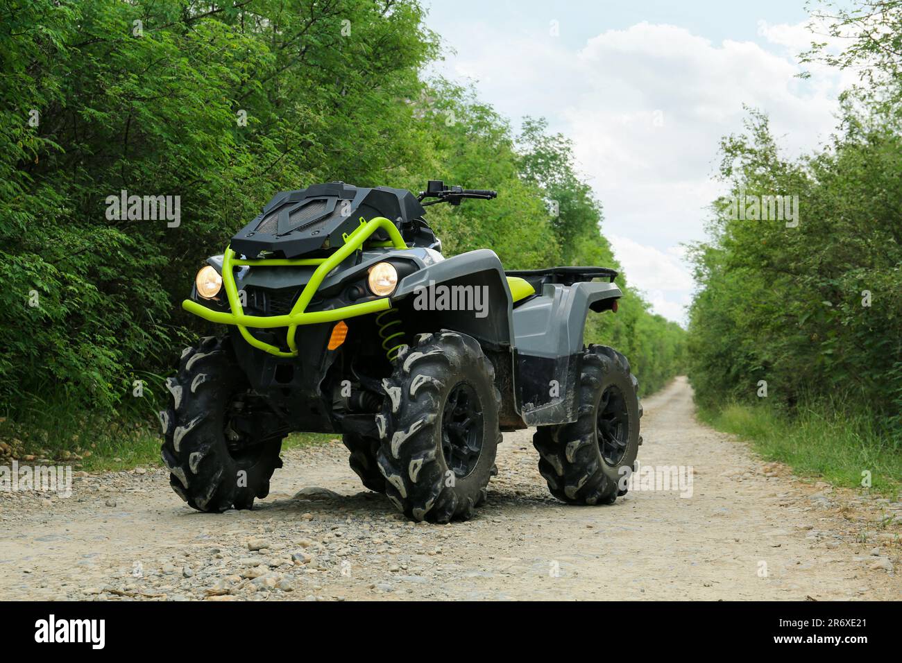 Modern quad bike on pathway near trees outdoors Stock Photo - Alamy