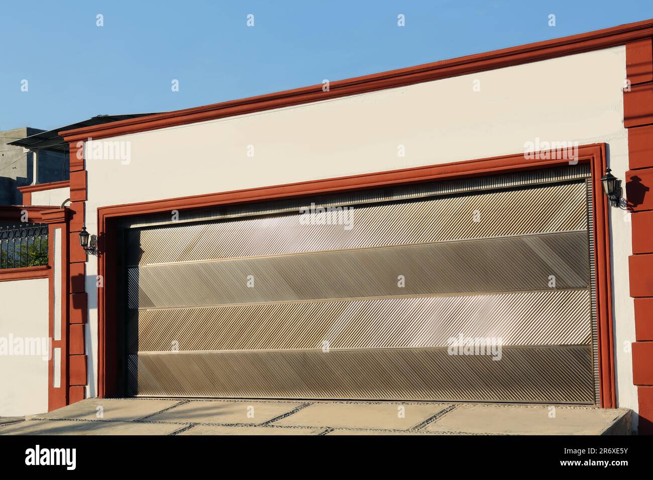 Garage building with closed sectional metal gate Stock Photo - Alamy