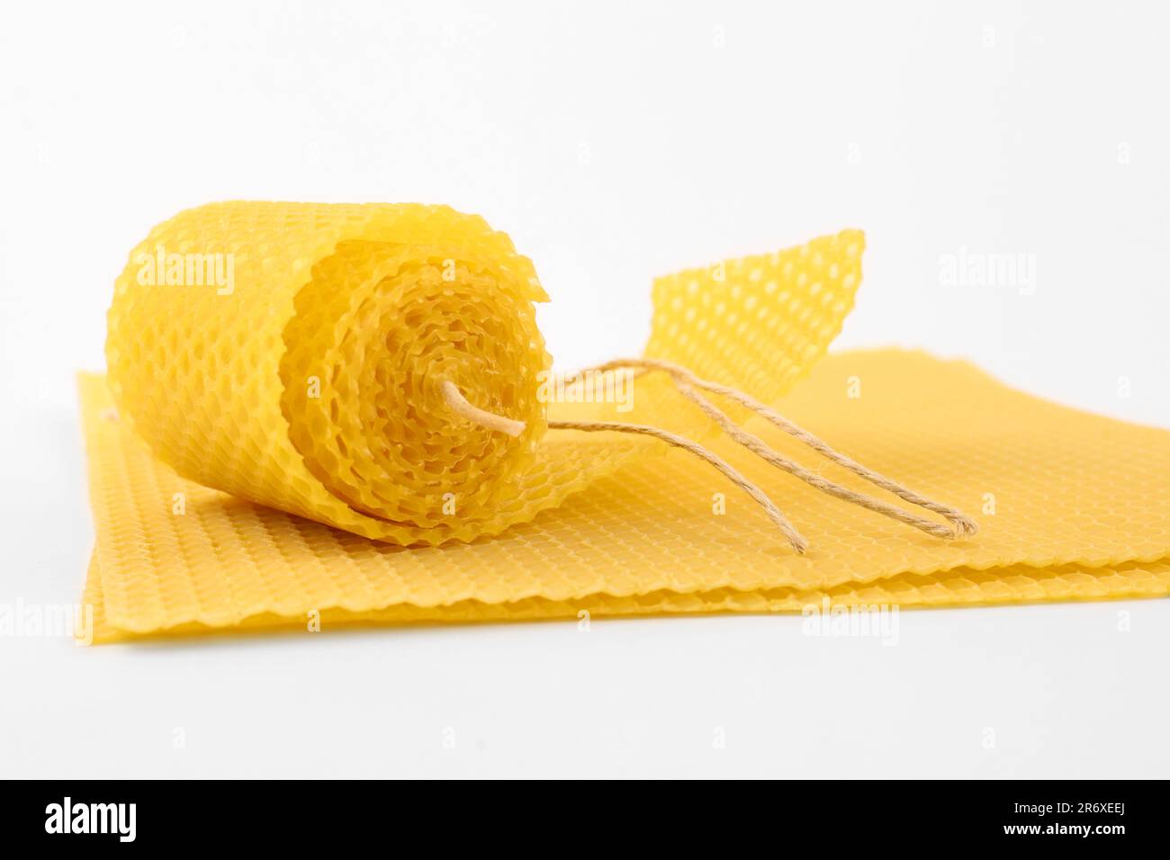 Stylish elegant beeswax candle and wax sheets on white background Stock ...