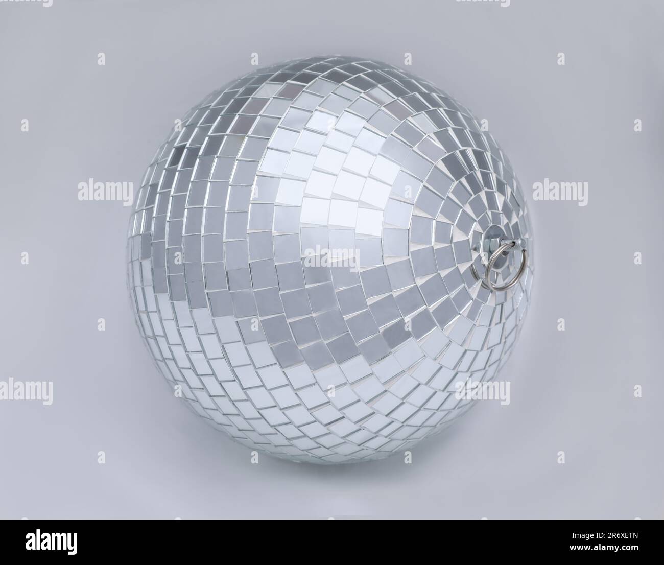 One shiny disco ball on light grey background Stock Photo - Alamy
