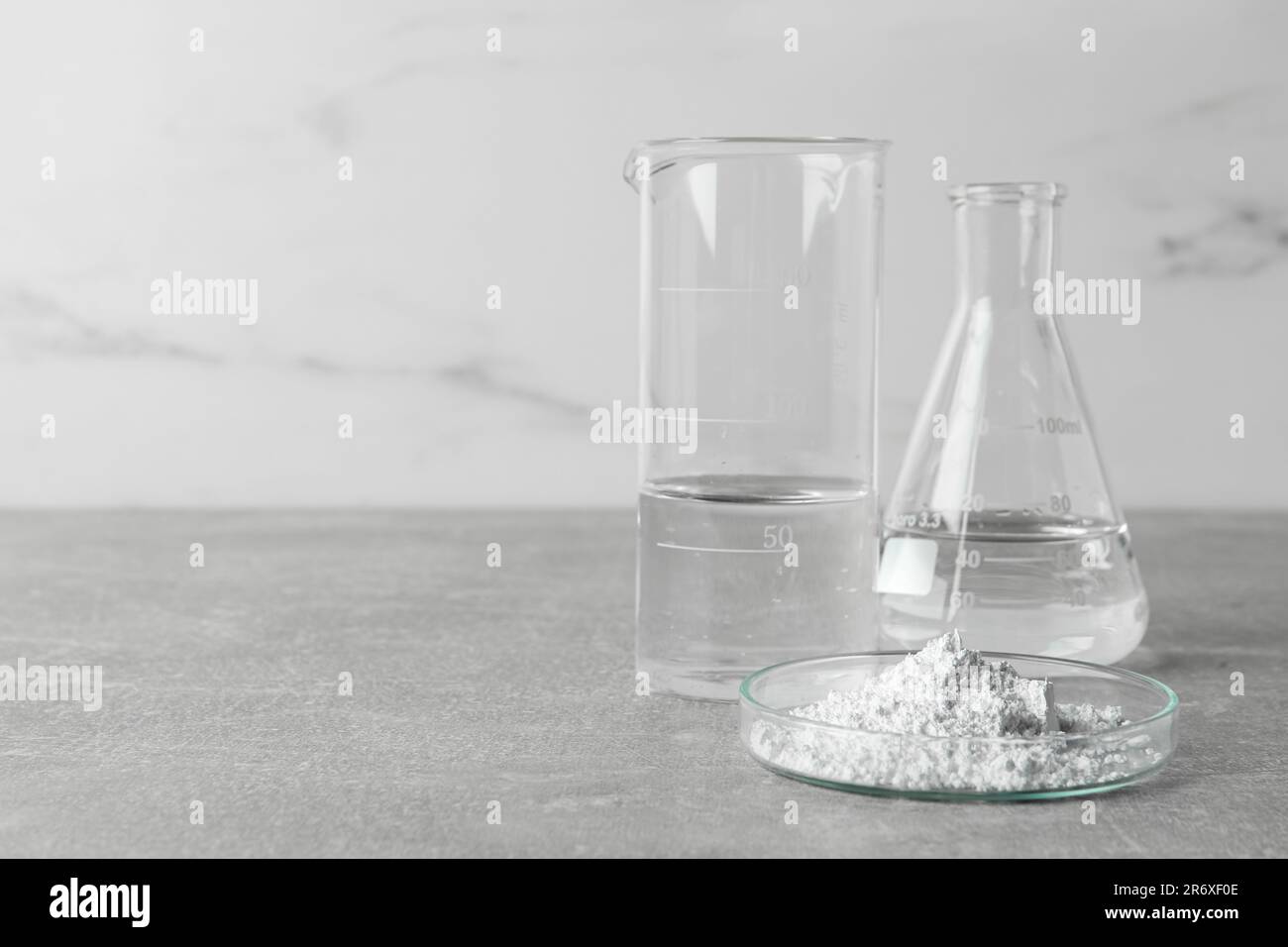 Petri dish with calcium carbonate powder and laboratory glassware on ...