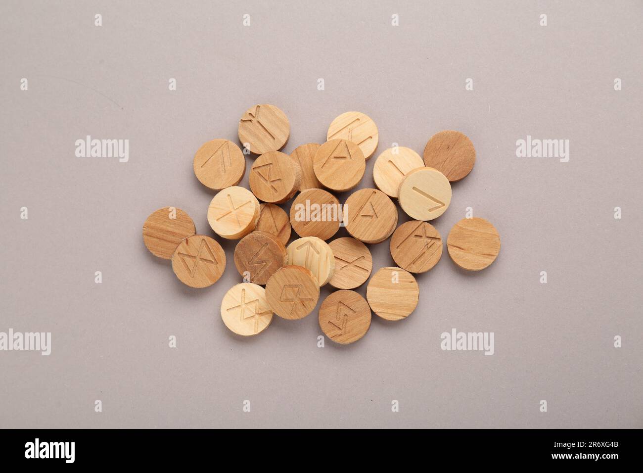 Pile of wooden runes on light grey background, flat lay Stock Photo - Alamy