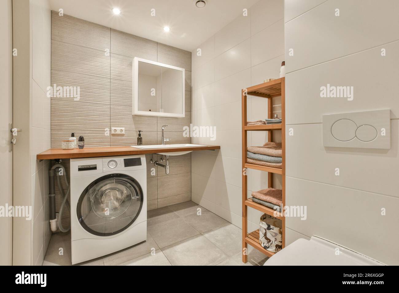 a small laundry room with a washer and dryer in the corner, next to a ...