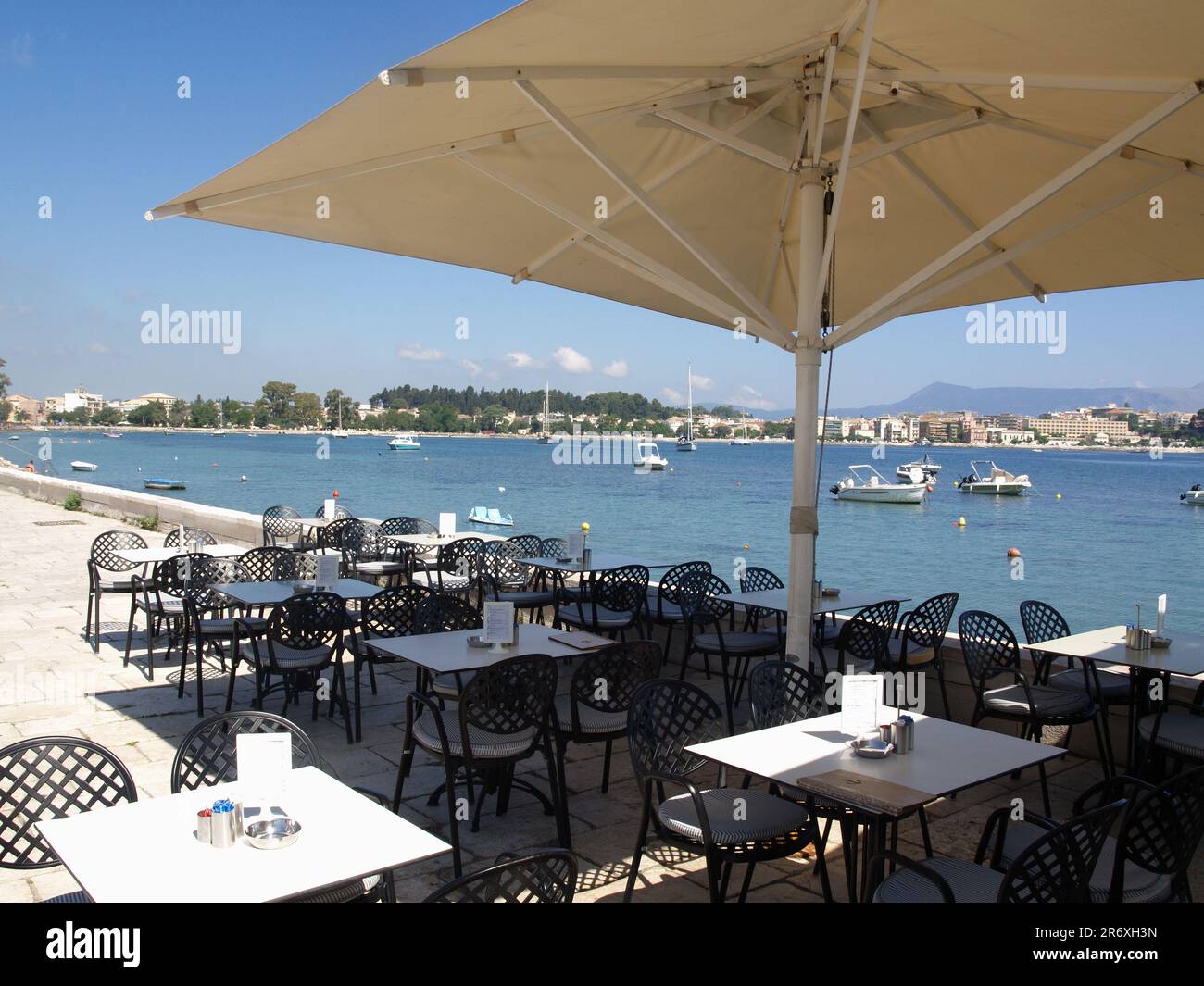 Empty tables at Nautilus Cafe Restaurant, Garitsa Bay, Corfu Town ...