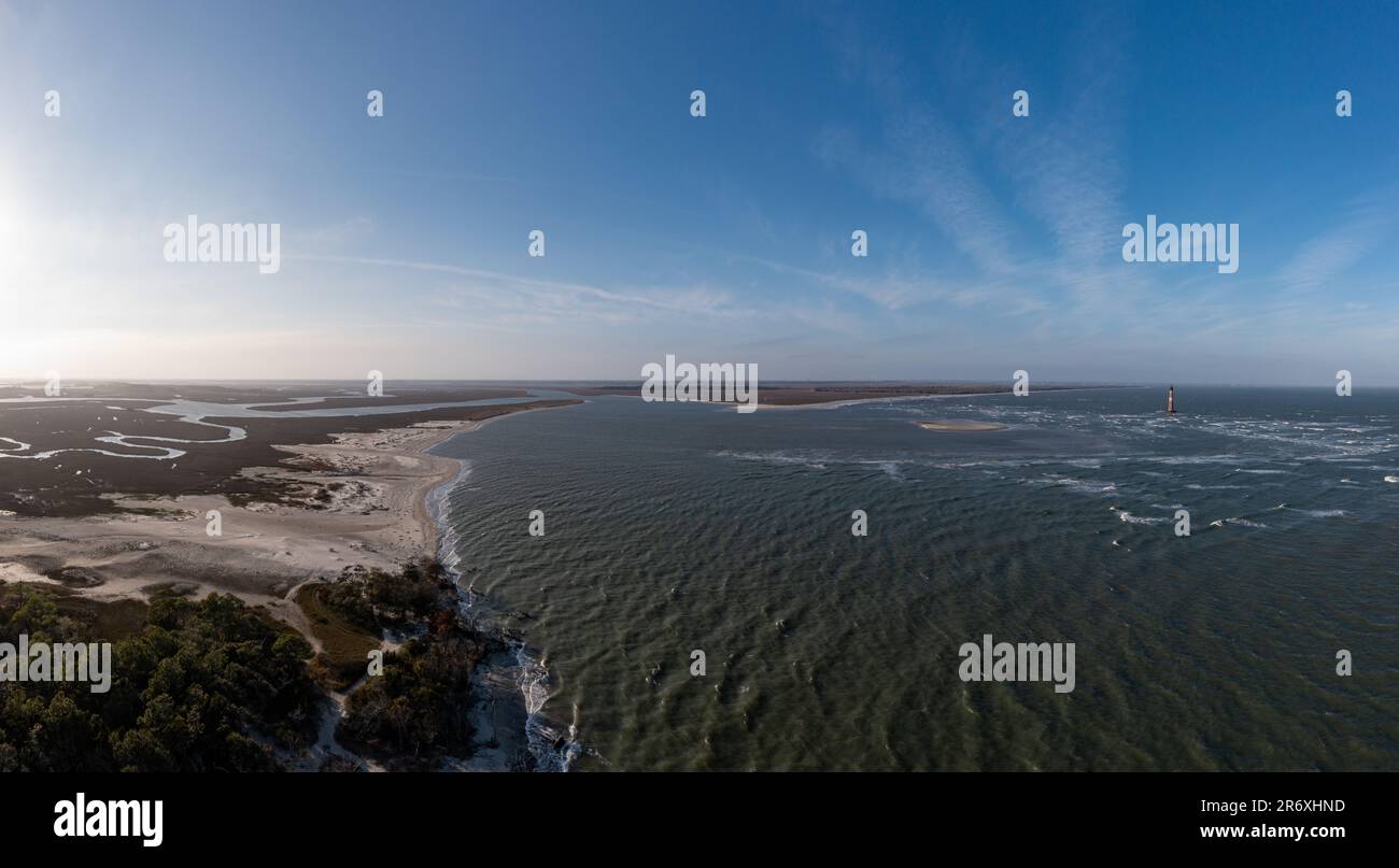 Sand and sea grasses on Folly Beach near Morris Island Lighthouse in ...
