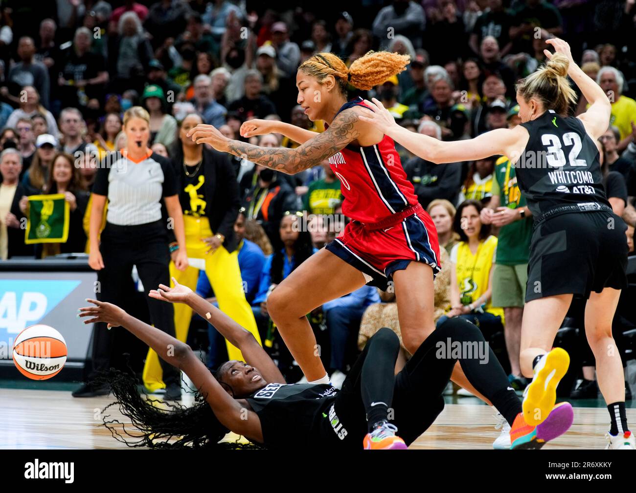 Seattle Storm center Ezi Magbegor, bottom, falls on the ground as the ...