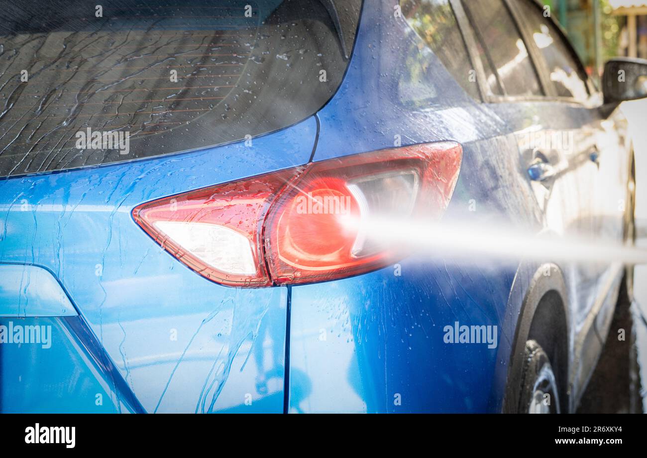 Car washing with high pressure water spray. Car cleaning. Auto care ...