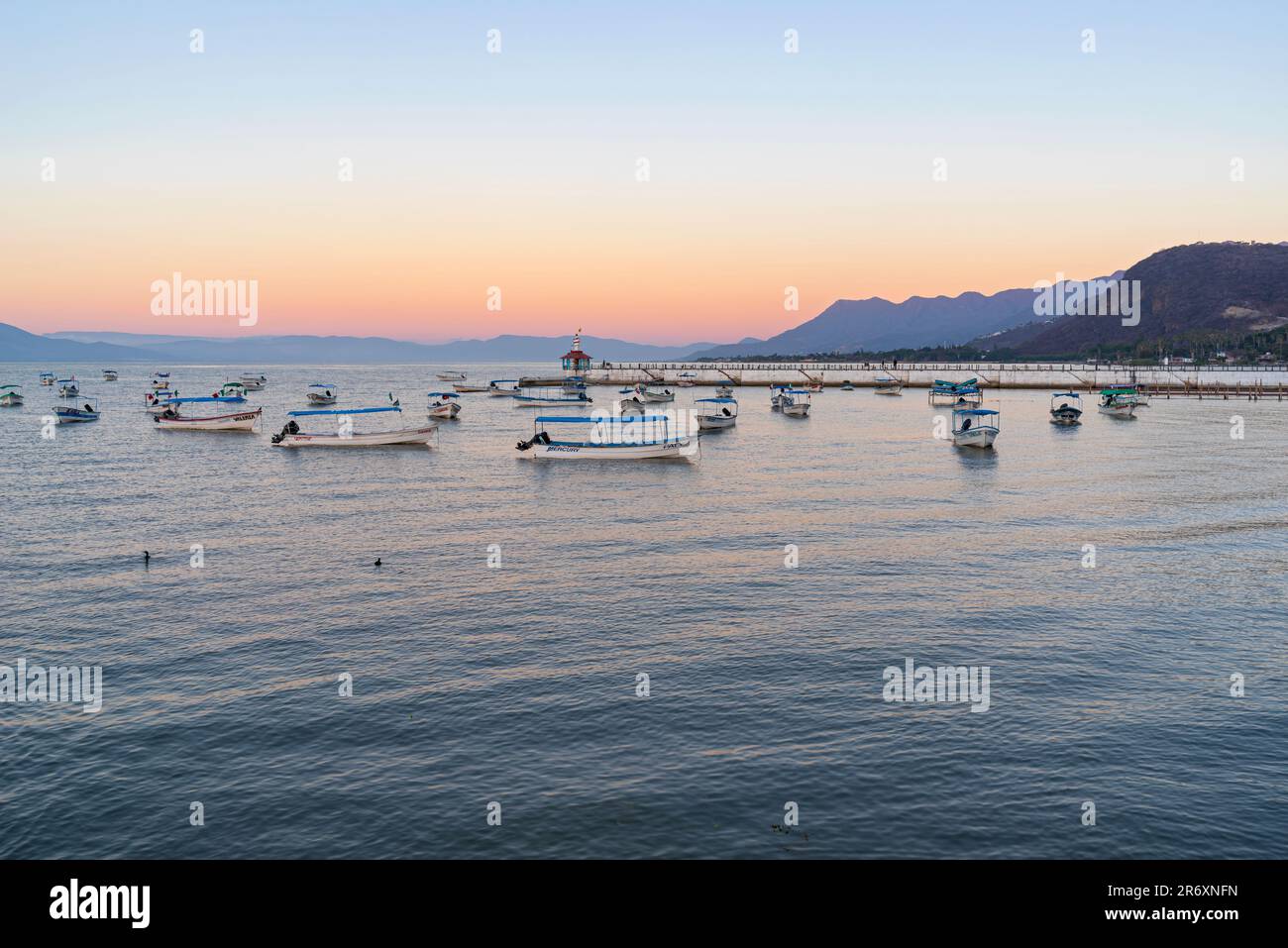 CHAPALA, JALISCO, MEXICO - MARCH 4, 2023: Boats anchored and pier on ...