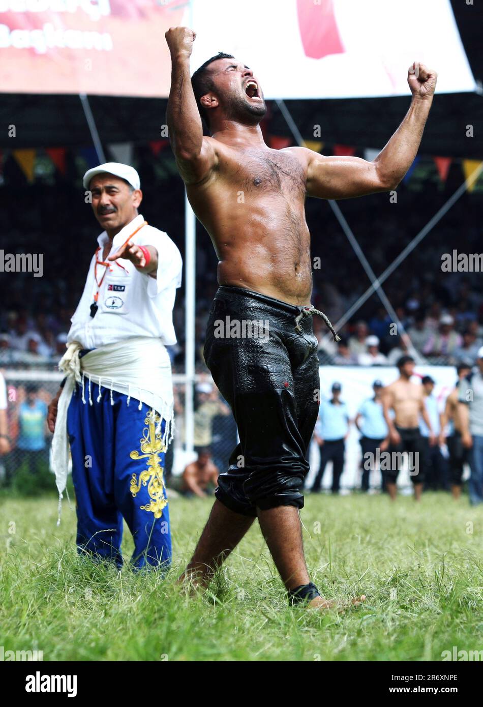 A victorious wrestler celebrates after winning his division of ...